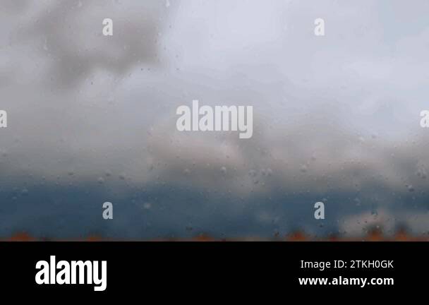 Rainy cloudy day outside the window. Foggy window glass with drops of ...