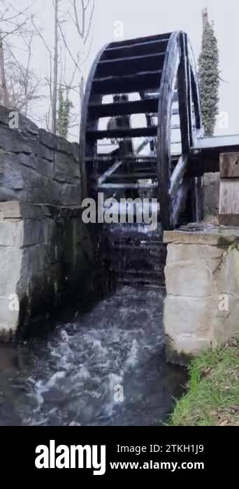 Work of water mill. Vertical video of water wheel that demonstrates ...