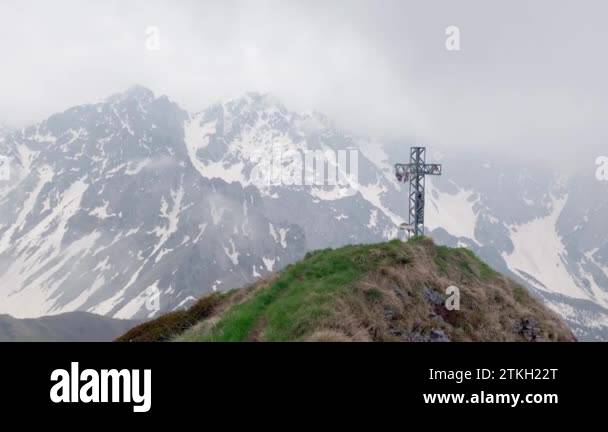 Metal crucifix built on the top of the mountain. attached to the cross ...
