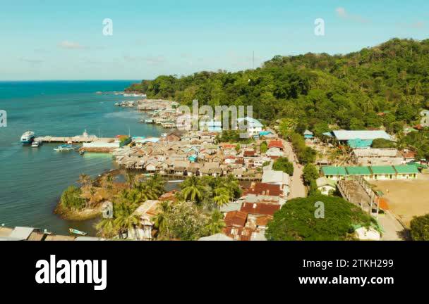 Houses community standing in water in fishing village. City port on ...