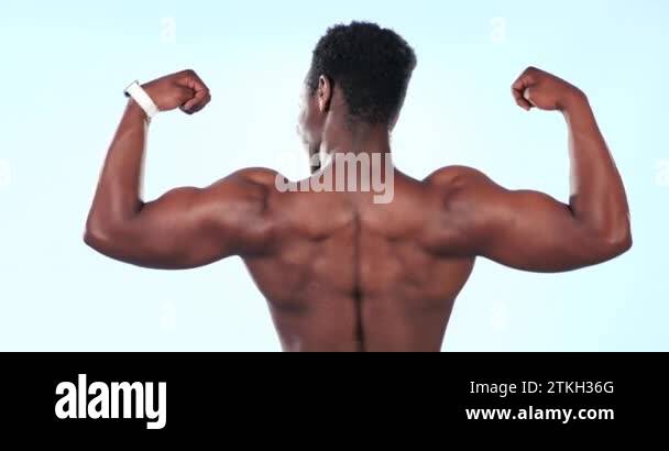 Strong, muscle and black man flexing biceps, bodybuilder in studio with ...