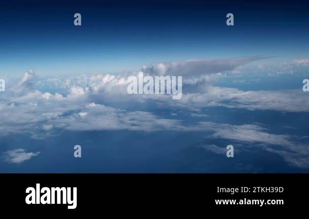 Stunning footage of aerial view above clouds from airplane window with ...