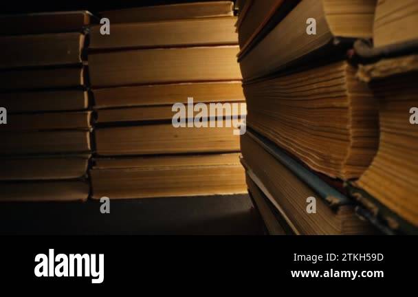 Library stack of old books, slider macro footage, camera moving between ...