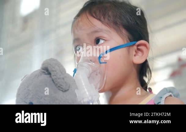 Kid girl making makes inhalation nebulizer steam sick cough at home ...