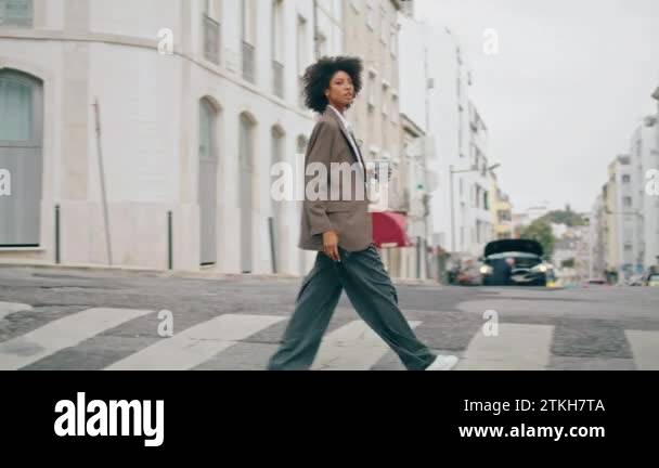 Busy attractive business woman going on crosswalk beautiful city with ...