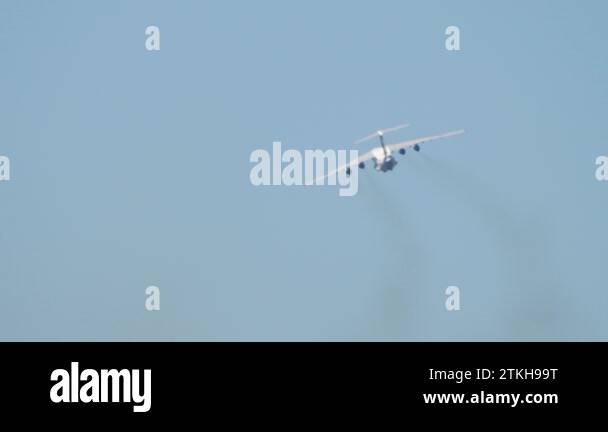 Heavy transport four-engine aircraft climb after takeoff, rear view ...