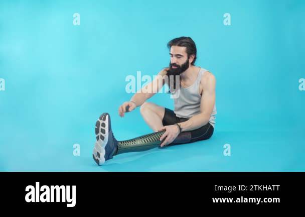 Studio video with copy space and blue background of a sportive man with ...