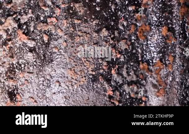 The wall of a wood-burning heating boiler with soot and tar close-up ...