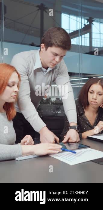 Vertical Screen: Managers having business meeting in office. Team ...