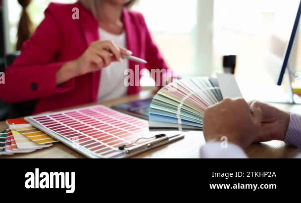 Designer helping client choose color using swatch fan closeup 4k movie ...