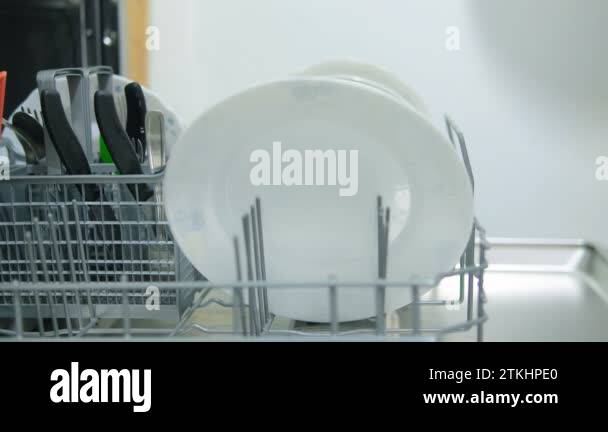 Person use dishwasher machine as housekeeping daily routine, domestic ...