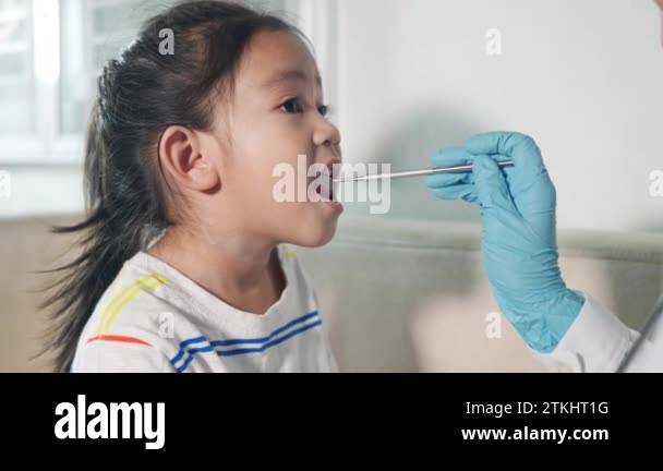 Dental kid health examination. Asian dentist making examination procedure for cute little girl ...