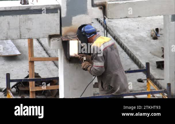 Electric welding at a construction site. Working man professional ...
