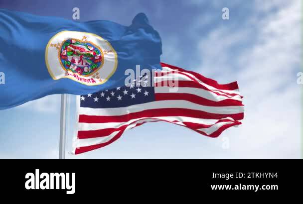 Minnesota state flag waving with the national american flag on a clear ...