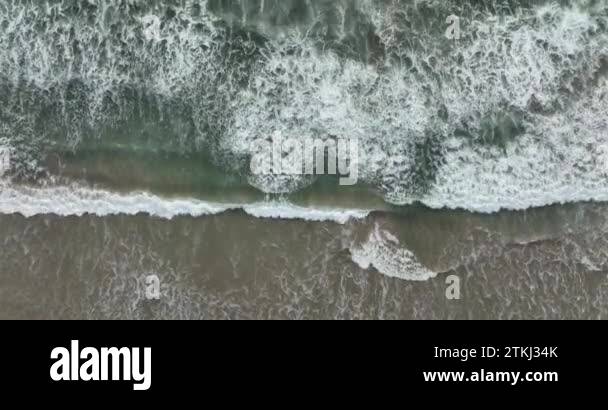 Waters of the ocean, swirl on the beach and scenic coastline. 4K Aerial ...