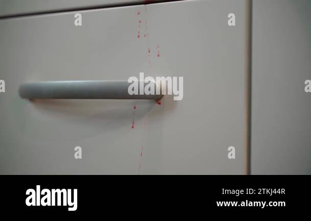 Red traces of blood on the facades of the kitchen close-up. Shelf ...