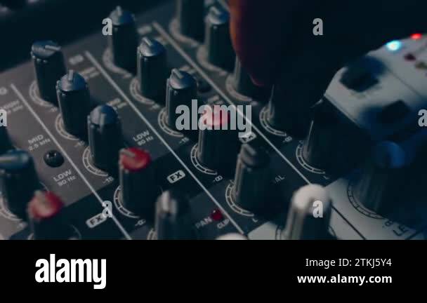 Close-up of fingers adjusting sound mixing console. Mixer console for ...