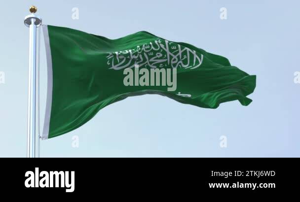 Saudi Arabia national flag waving in the wind on a clear day. Green ...