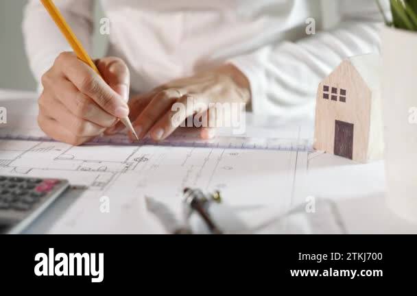 Architectural project workplace. Architect drawing with ruler on house ...