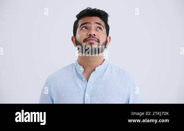 Happy Indian man with piercing wearing blue shirt looking around and at ...