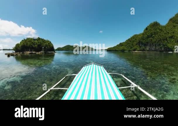Boat over turquoise water in lagoons in Tinago Island in Tagana-an ...