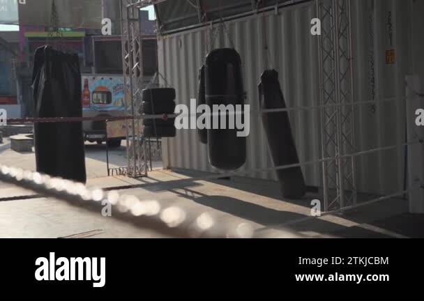 Empty boxing and martial arts area on street gym with many punching ...