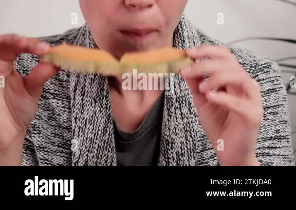 A middle-aged woman eats a melon. Proper nutrition, eating fruits ...