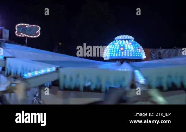 Carousel with lights. Theme park. Popular swing rides. Colorful ...
