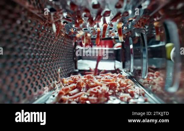 Slow motion close-up video of grating red cheese for pizza and pasta in ...