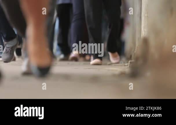 a close-up of walking legs. Legs of Crowd People Walking on the Street ...