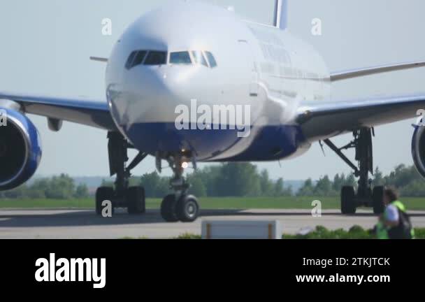 Boeing 777 taxiing on runway to the parking lot after landing Stock ...
