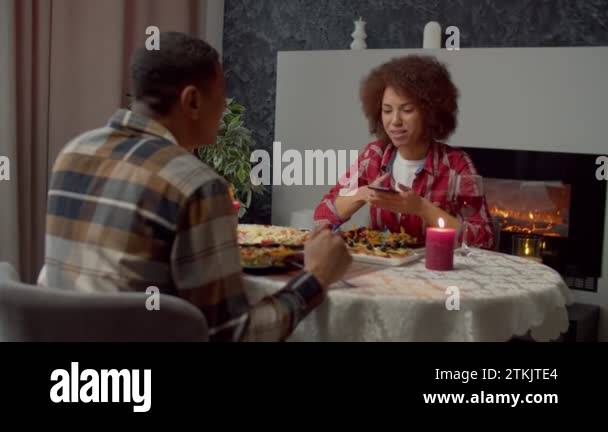 Happy charming black female enjoying tasty canapes with salmon ...