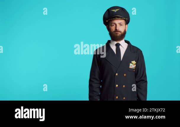 Male model wearing pilot uniform and hat on camera, having professional ...