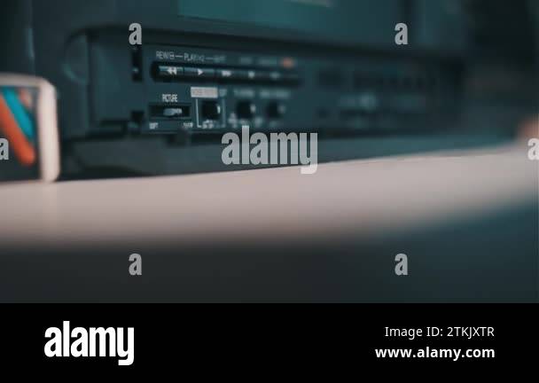 Insert VHS cassette into VCR player. Black vintage videotape cassette ...