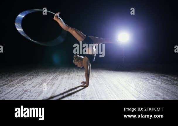 Professional female circus acrobat rotate hula hoop on scene Stock ...