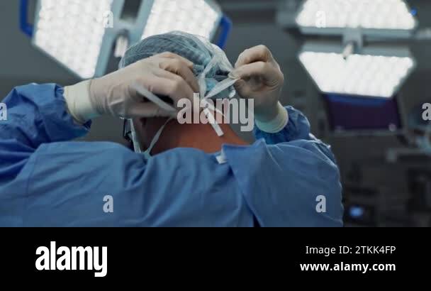Surgery, hospital and doctor tie mask in operating room for medical ...