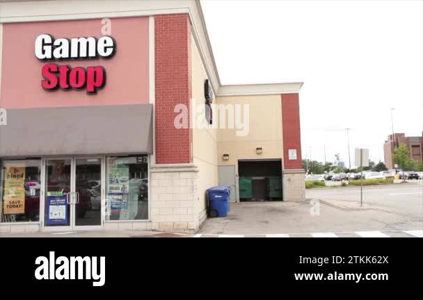 game stop store storefront entrance with logo on beige building writing ...