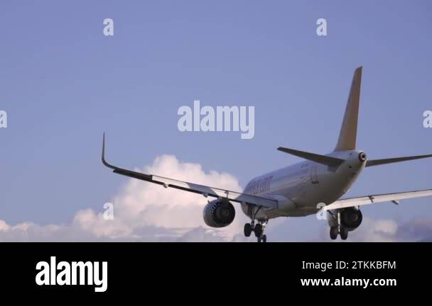 Batumi, Georgia - 2023, July 5: Landing plane against colorful blue sky ...