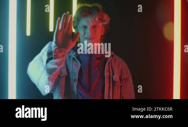 Slow motion portrait of annoyed young man stretching arm asking to stop ...