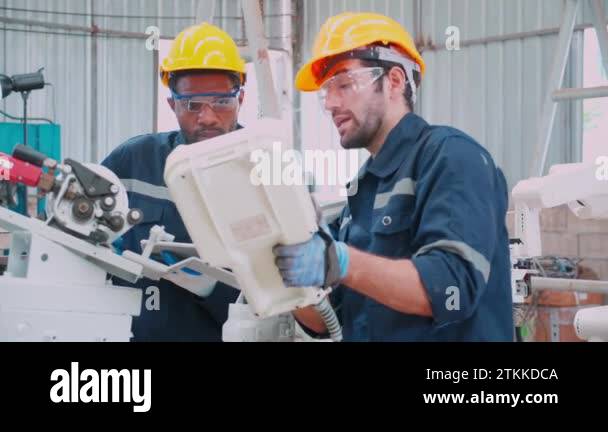Two young engineer man talking and explaining about robot arms ...