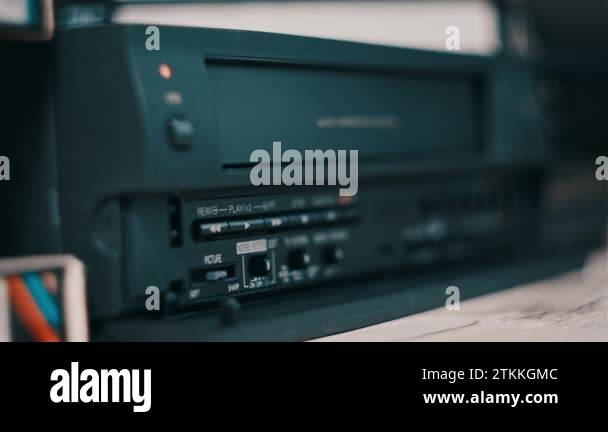 Insert VHS cassette into VCR player. Black vintage videotape cassette ...