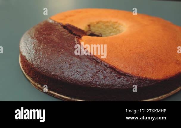 Delicious baked two-color cake with lies on the table in a baking dish ...