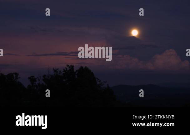 Dramatic evening sky with full moon and storm clouds rolling over ...