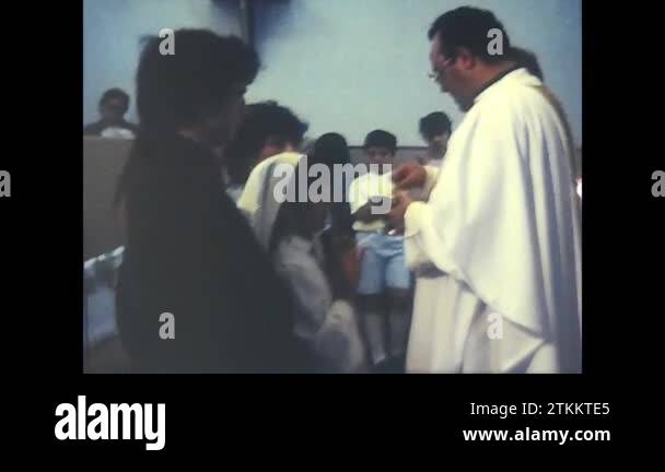 palermo, italy may 1980: A priest giving Communion wafer to a girl for ...