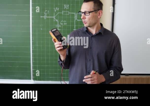High School Teacher explaining electrical voltage tester device To ...