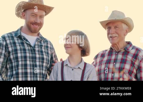 Horizontal shot. Three generations of smiling farmers. Cheerful father ...
