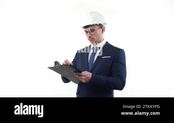 A young engineer in a suit and hard hat in slow motion makes important ...