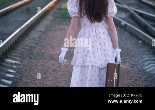 Back view unrecognizable young slim woman in vintage dress with ...