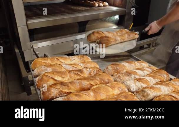 Craft mini-bakery producing French pastries. The baker takes freshly ...