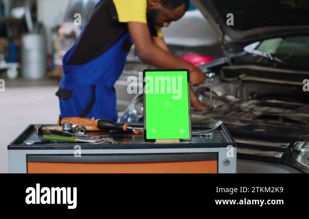 Mechanic in car service uses wrench to replace parts inside vehicle ...